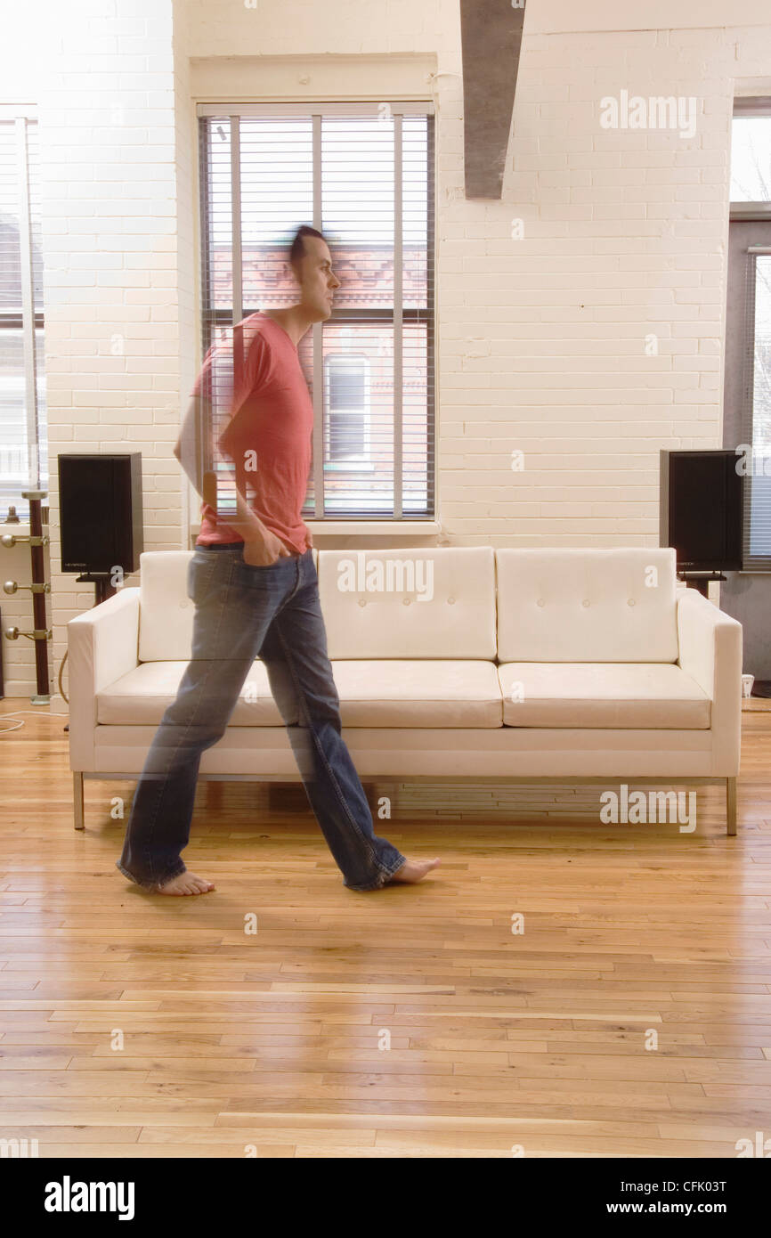 Blurred Image of Man Walking Across Room Stock Photo - Alamy