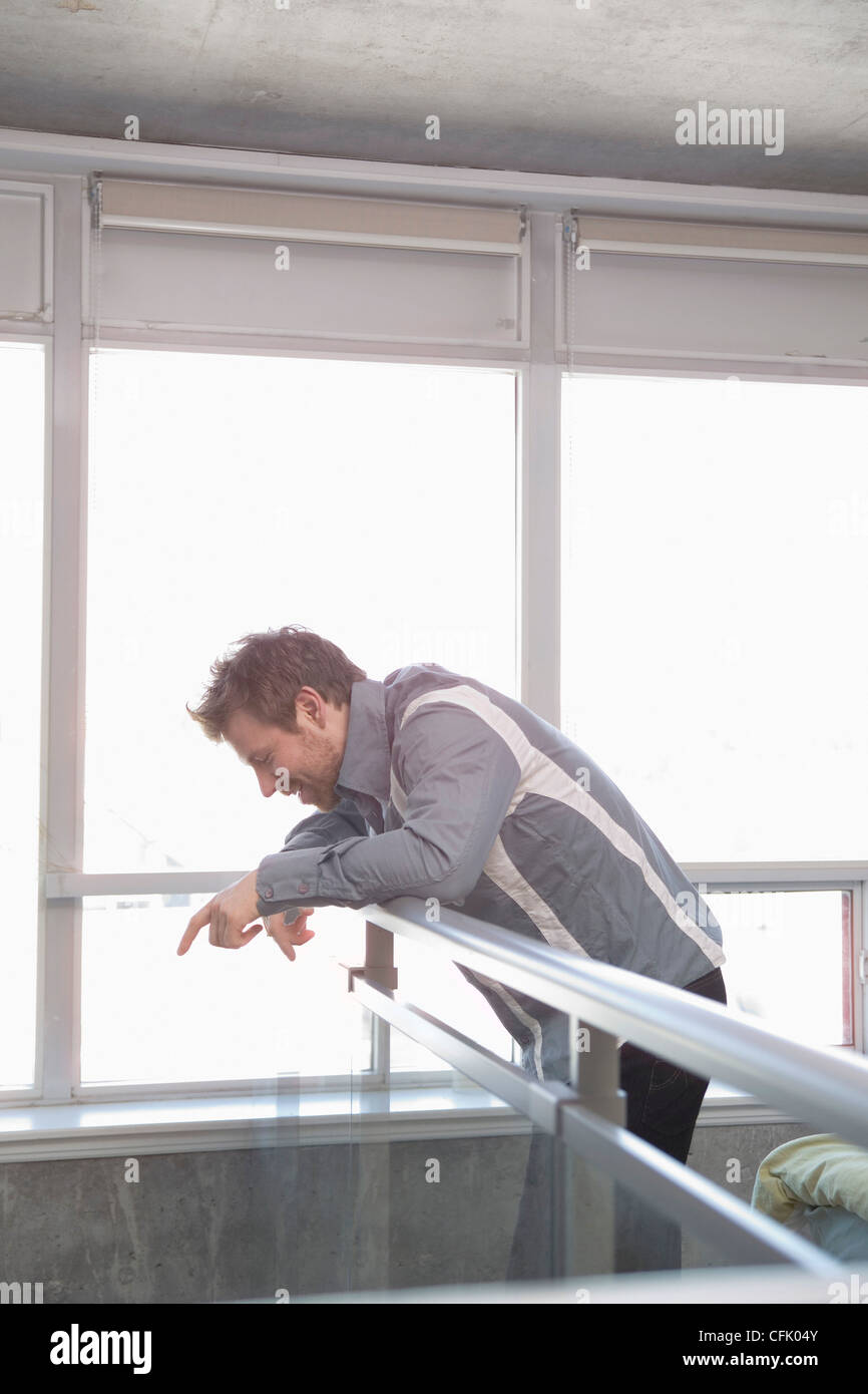 Man Looking Over Balcony Stock Photo - Alamy