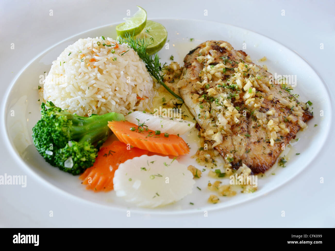roasted fish served with fried rice Stock Photo - Alamy