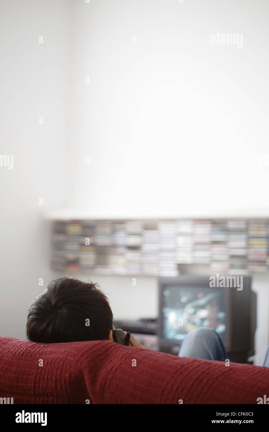 Man Watching TV while on the Phone Stock Photo - Alamy