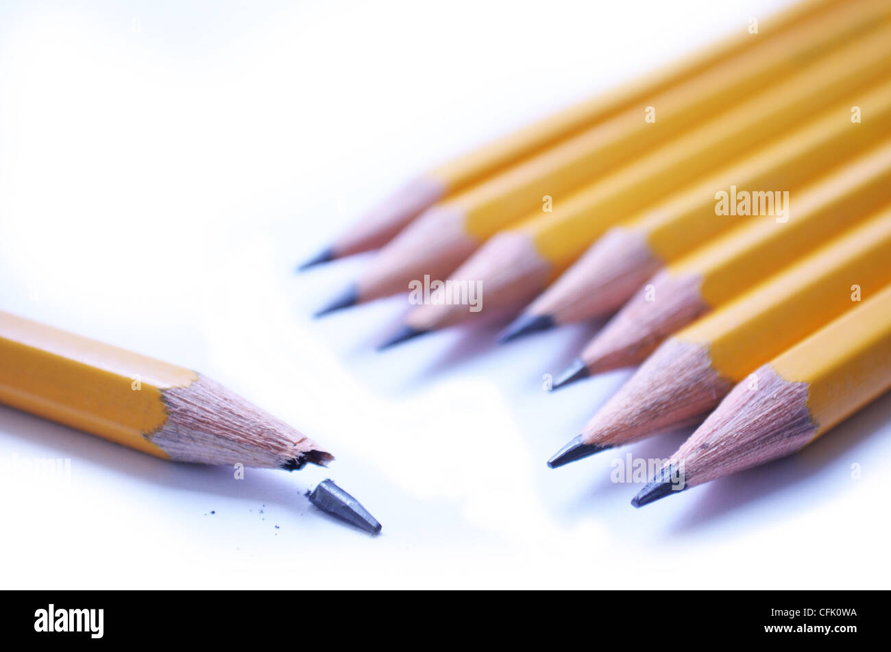 group of pencils against one pencil brokedown Stock Photo - Alamy