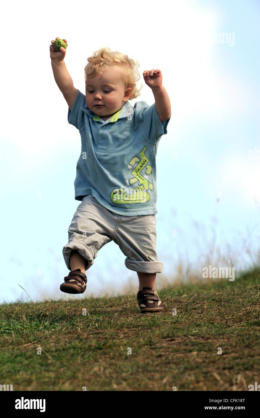 Toddler learning to walk Stock Photo - Alamy