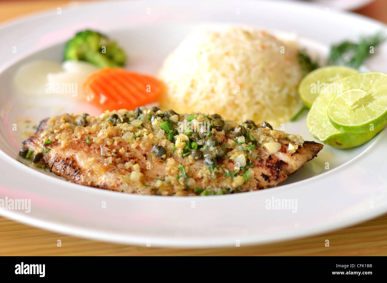 roasted fish served with fried rice Stock Photo - Alamy