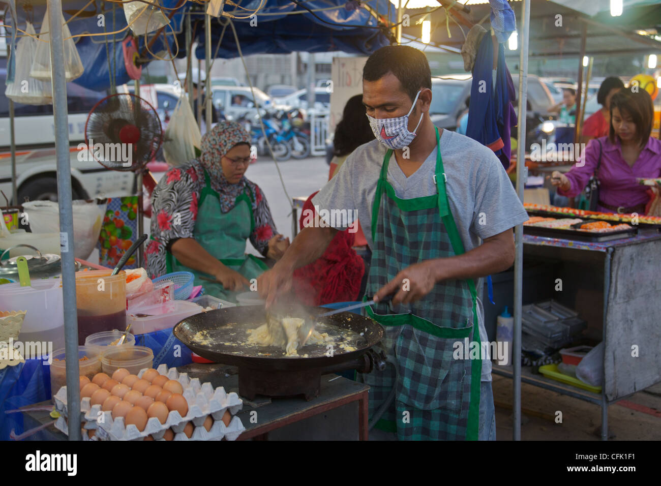 A Thai man cooking in a market in Phuket Stock Photo - Alamy
