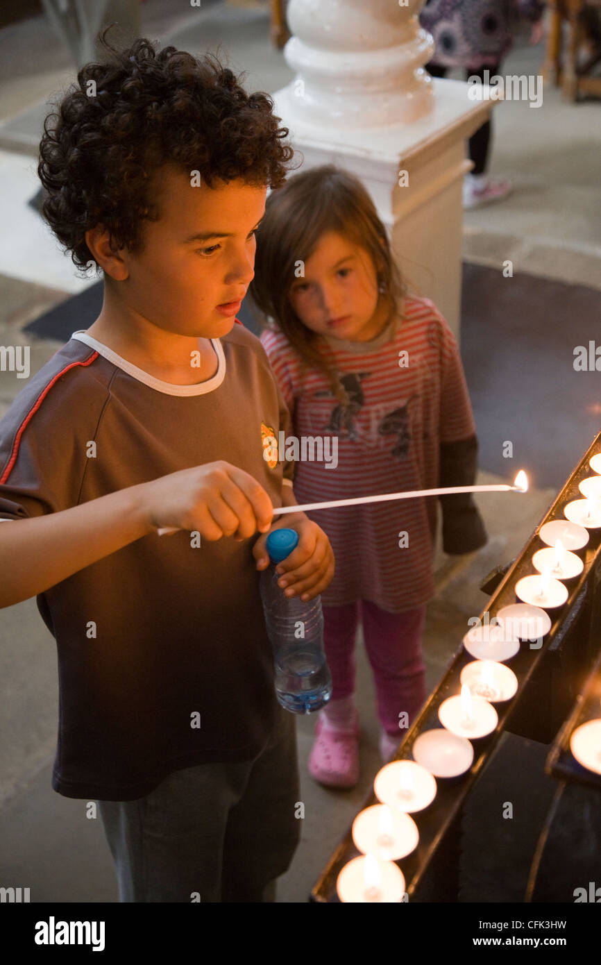 Two children lighting a candle in Whitby Church, Whitby, North ...