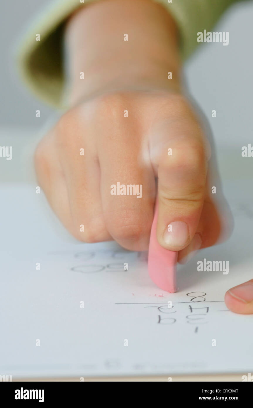 Child Erasing Work from Paper Stock Photo - Alamy