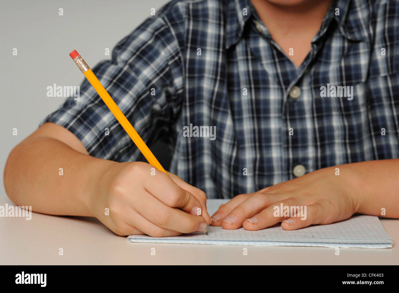 Boy Writing on Note Paper Stock Photo - Alamy