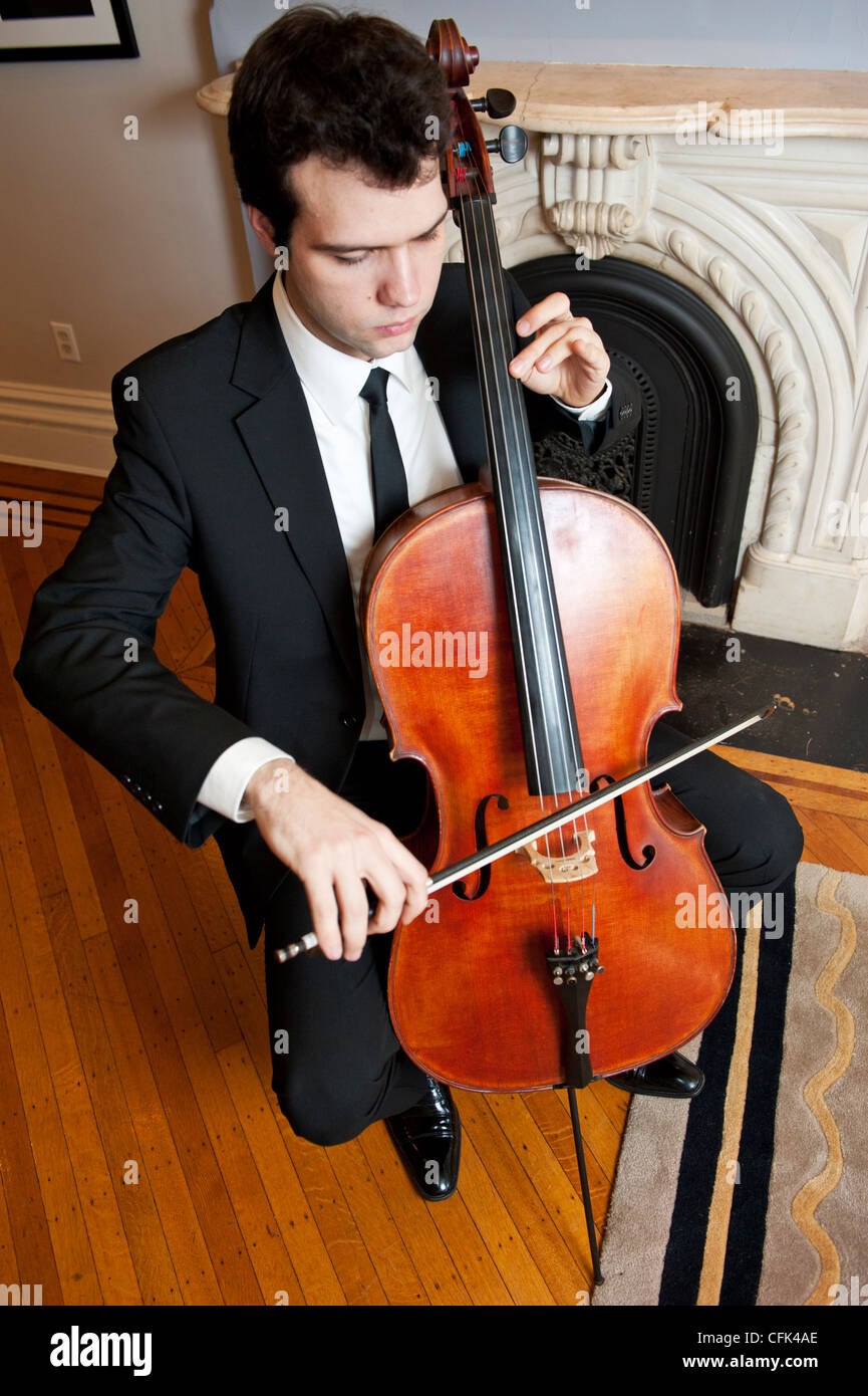 Handsome young man wearing a suit and tie playing the cello Stock Photo ...