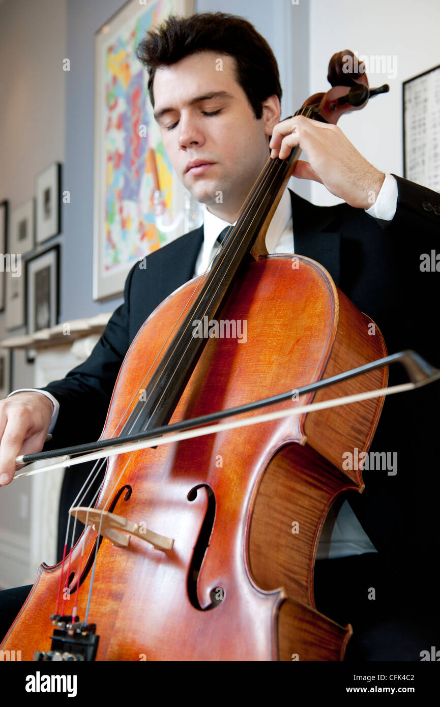 Handsome young man wearing a suit and tie playing the cello Stock Photo ...