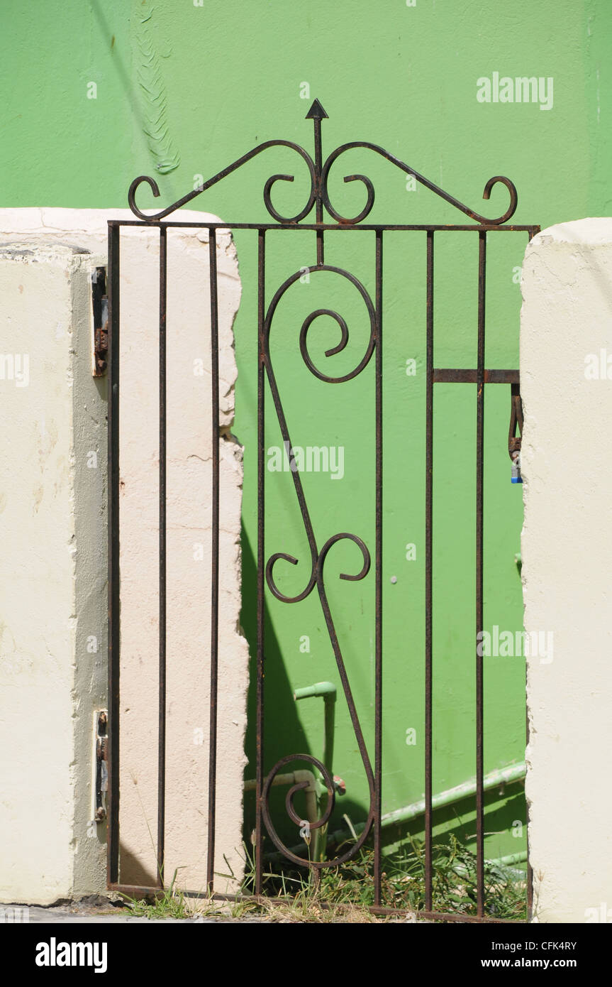 Gate in Caribbean house with a a green wall as background Stock Photo ...