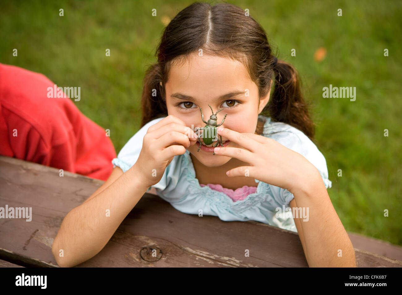 Girl with Insect on her Face Stock Photo - Alamy