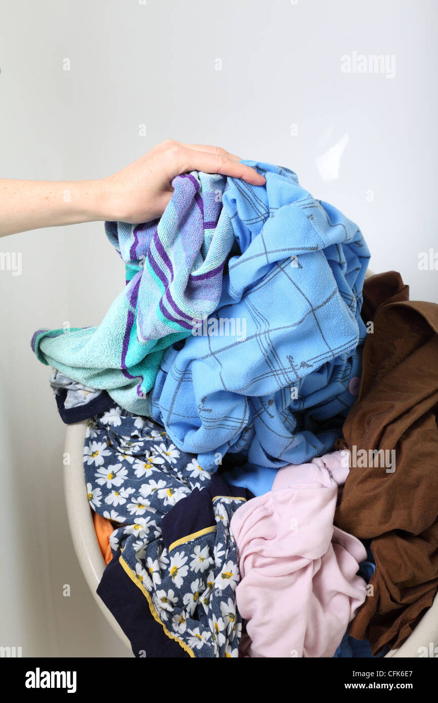 woman Pile of dirty laundry in bath washing machine green bathroom ...