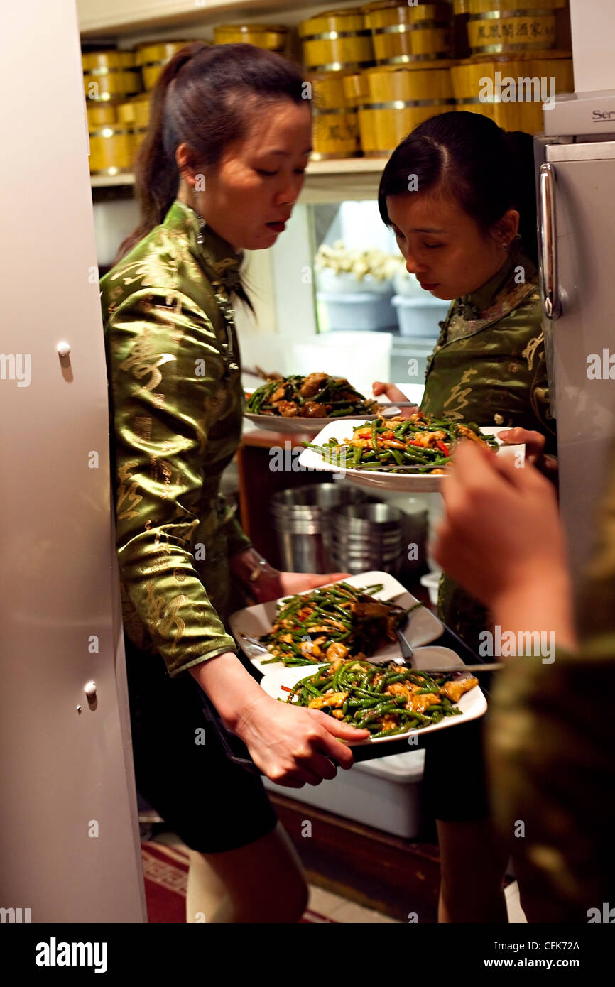 Chinese waitresses is bring out meals from kitchen Stock Photo - Alamy