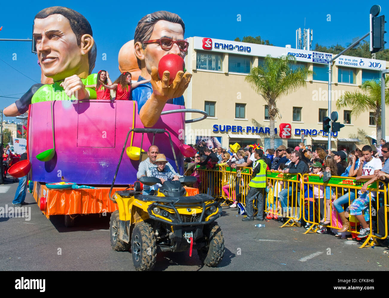 Colorful moving float pass through the street during the Adloyada event ...