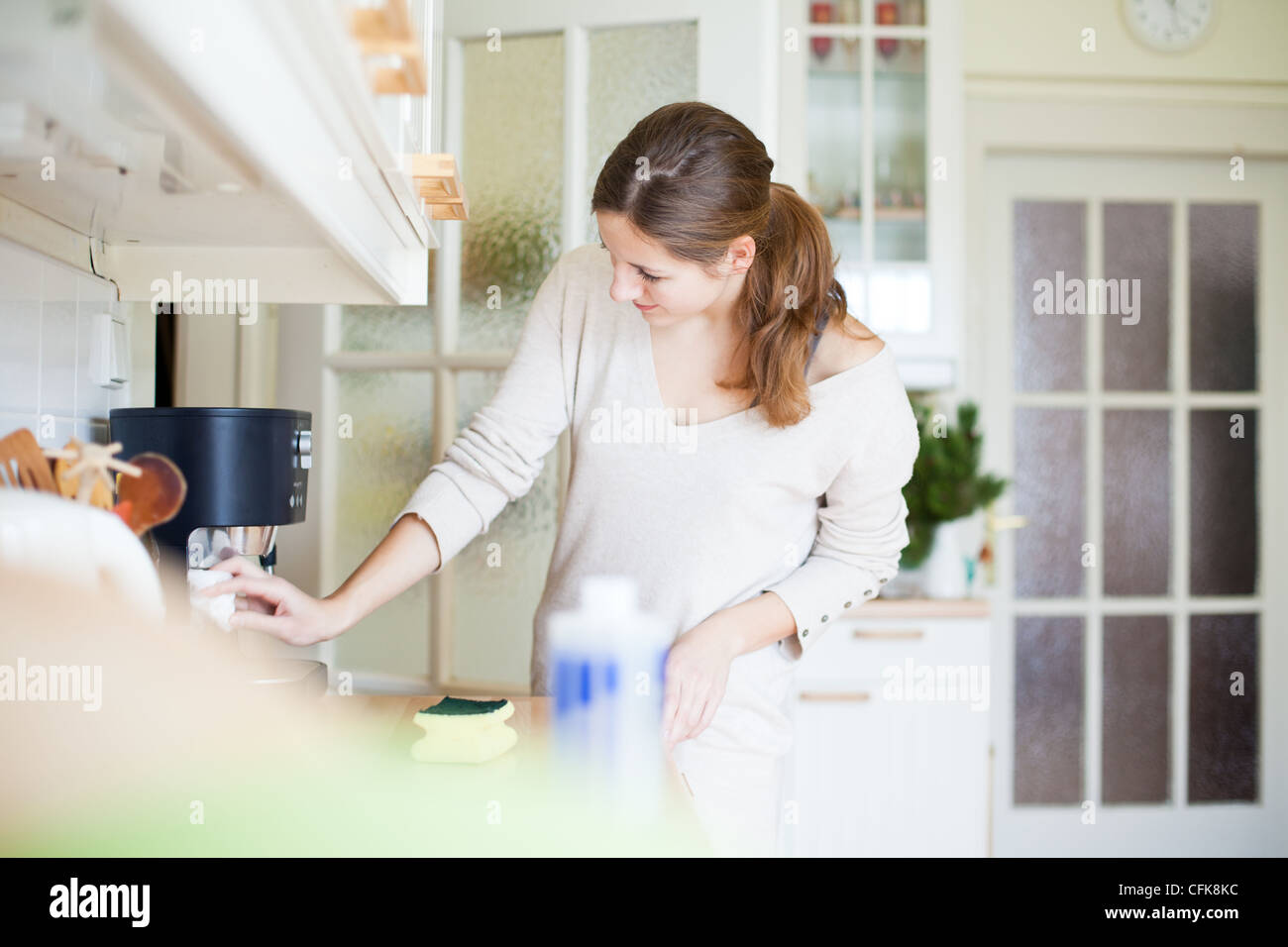Young woman doing housework, cleaning the kitchen Stock Photo - Alamy