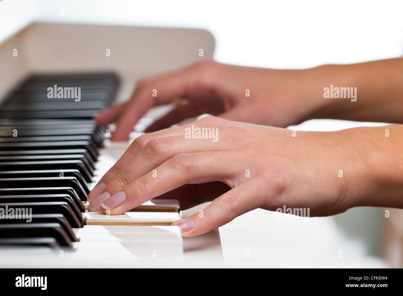 Playing the piano (shallow DOF; color toned image Stock Photo - Alamy
