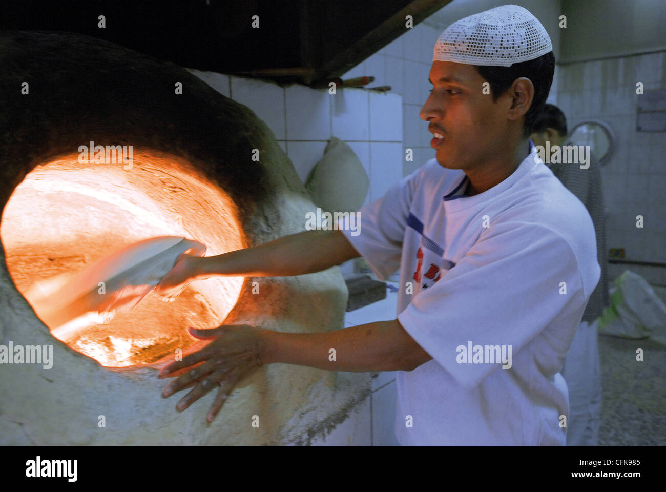 Bahrain, the baking of the arabian bread in the Manama market Stock ...