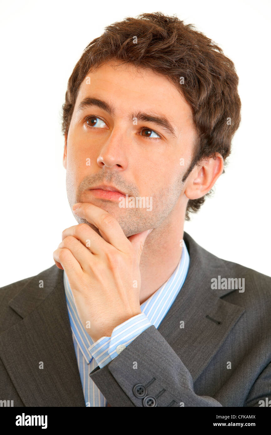Portrait of serious modern businessman looking in corner at copy space ...