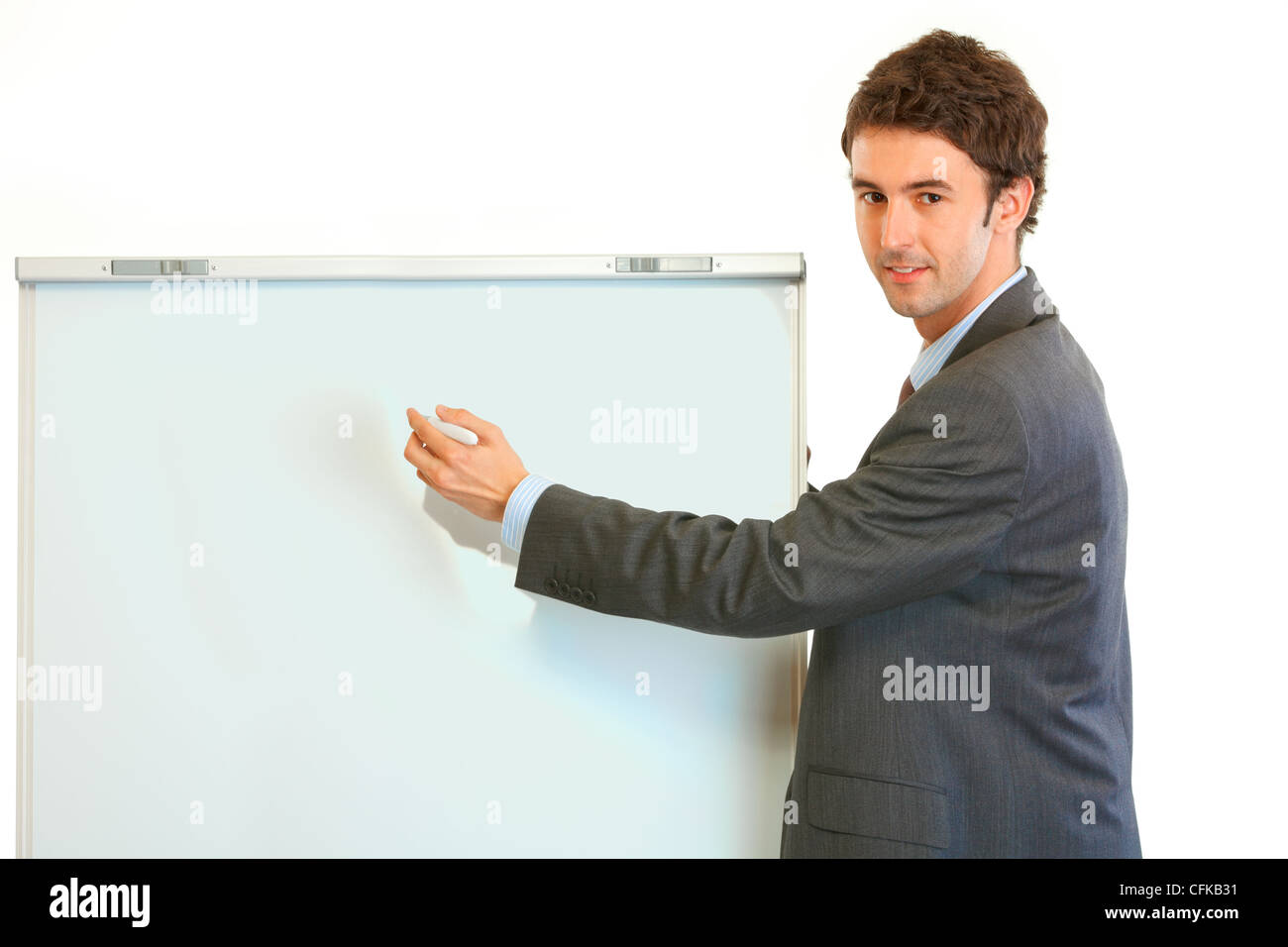 Smiling modern businessman giving presentation using flipchart isolated ...
