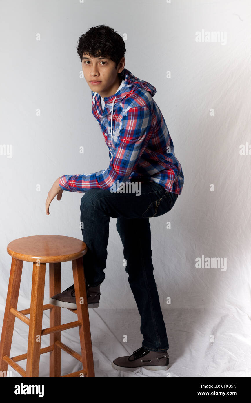 Handsome young Hispanic teenager, wearing red, white and blue plaid ...