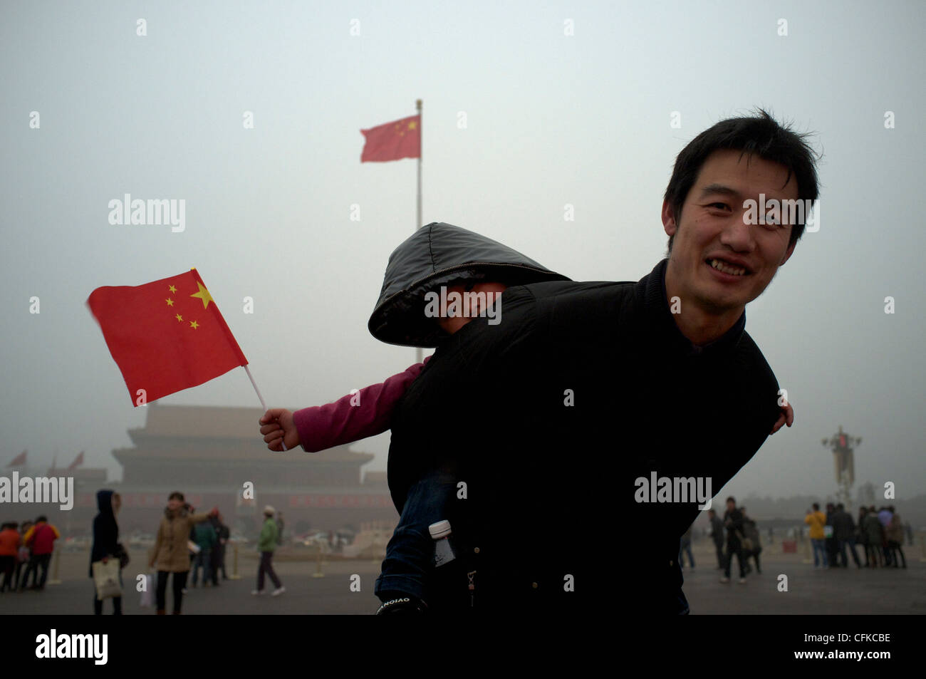 Chinese father carries son with National flag in Tiananmen Square in ...