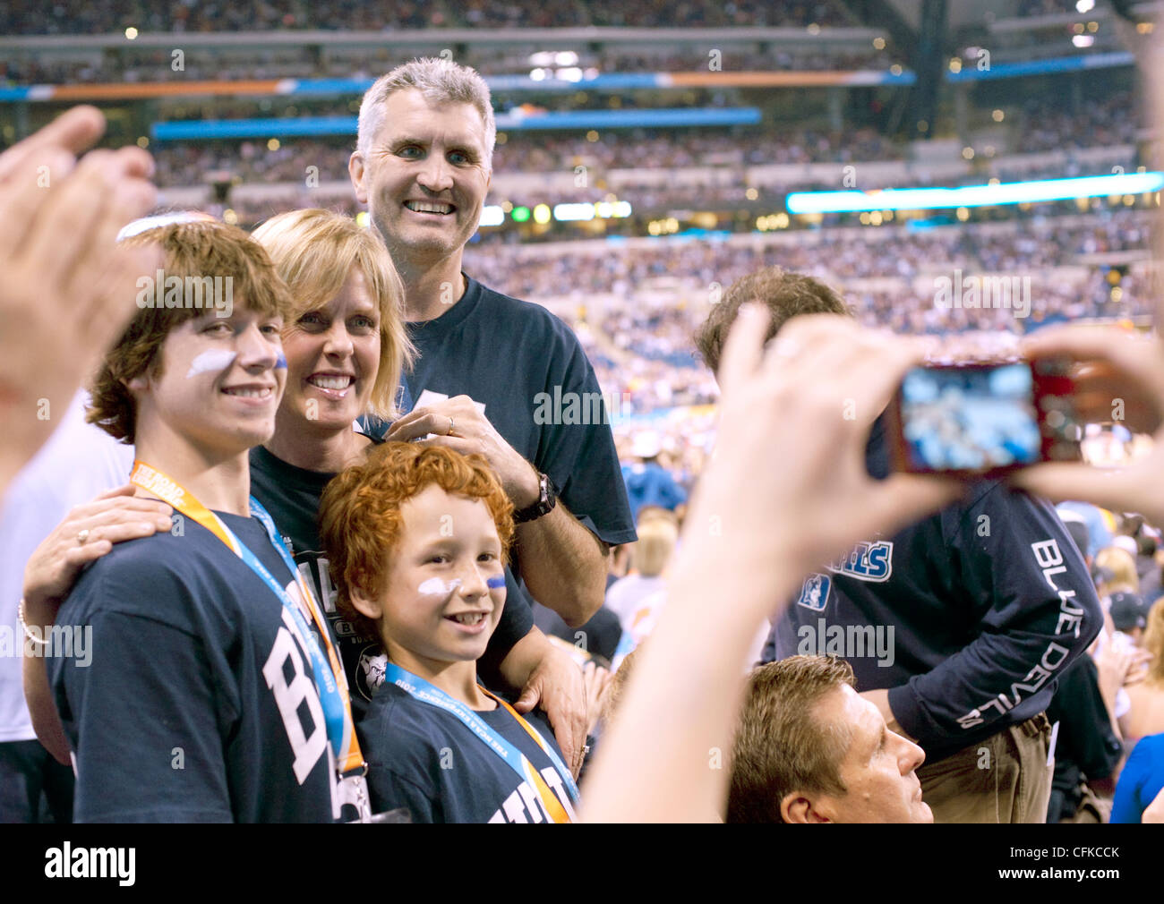 A family of Butler basketball fans have their photo taken in the crowd ...