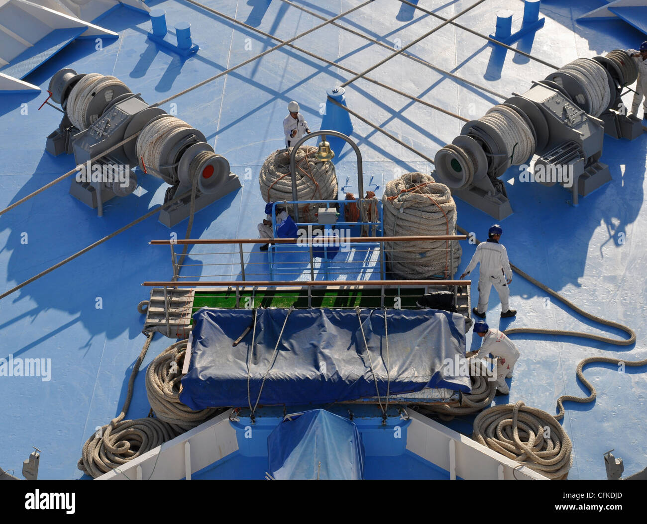 Deck hands using winch on cruise ship Stock Photo - Alamy