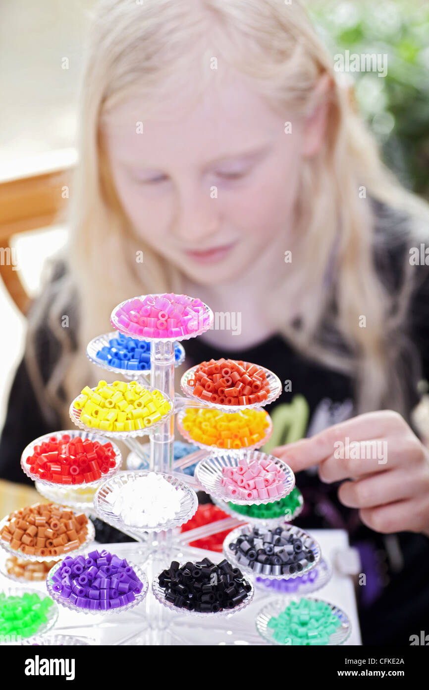 Little blond girl playing with Hama beads Stock Photo - Alamy