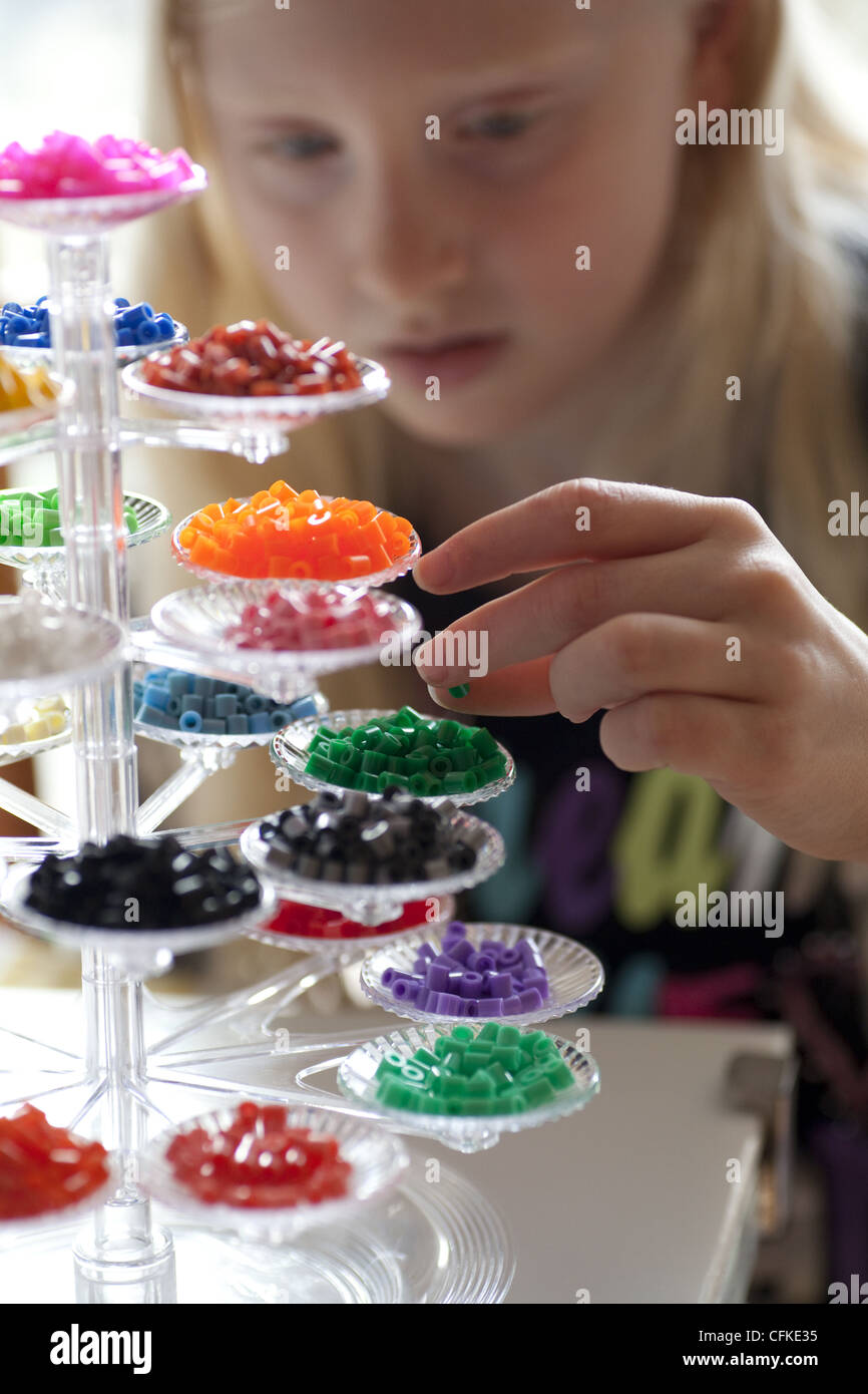 Little blond girl playing with Hama beads Stock Photo - Alamy