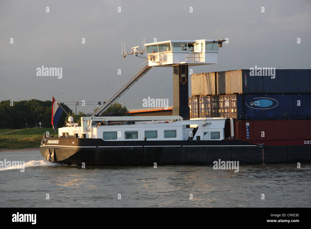 Adjustable bridge on a freighter loaded with containers approaching the ...