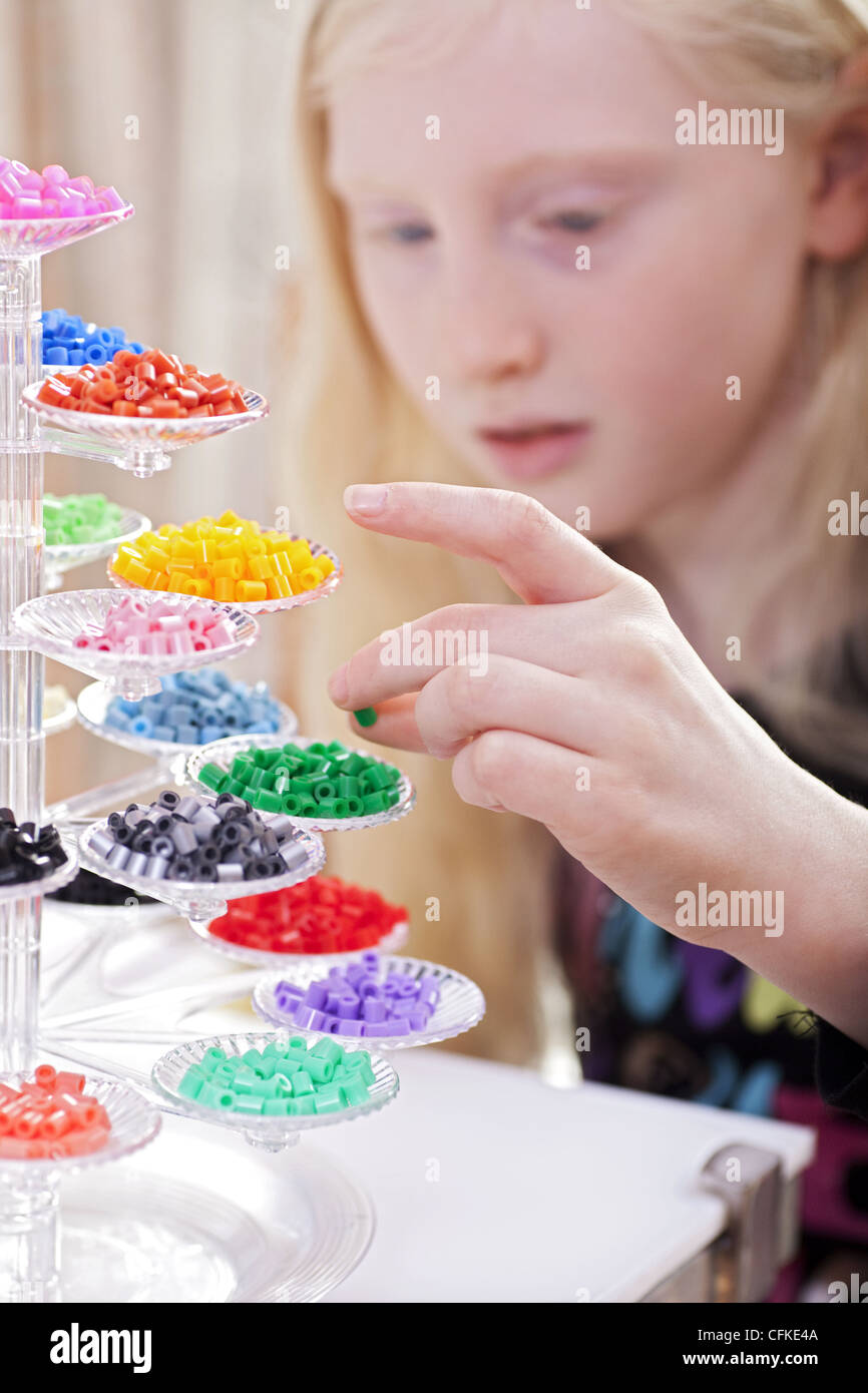 Little blond girl playing with Hama beads Stock Photo - Alamy