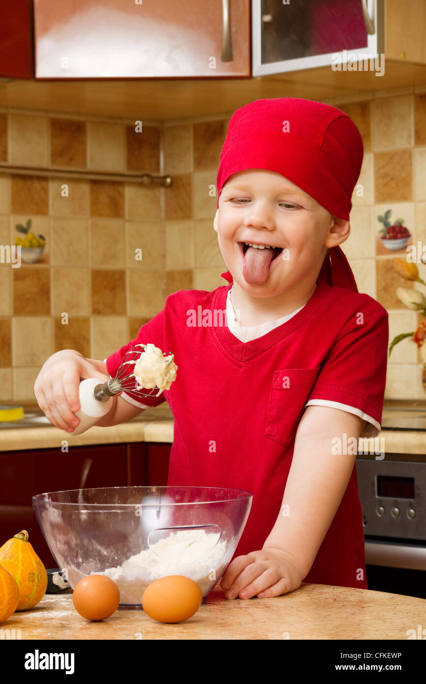 Small boy helping at kitchen with baking a pie, little chef Stock Photo ...