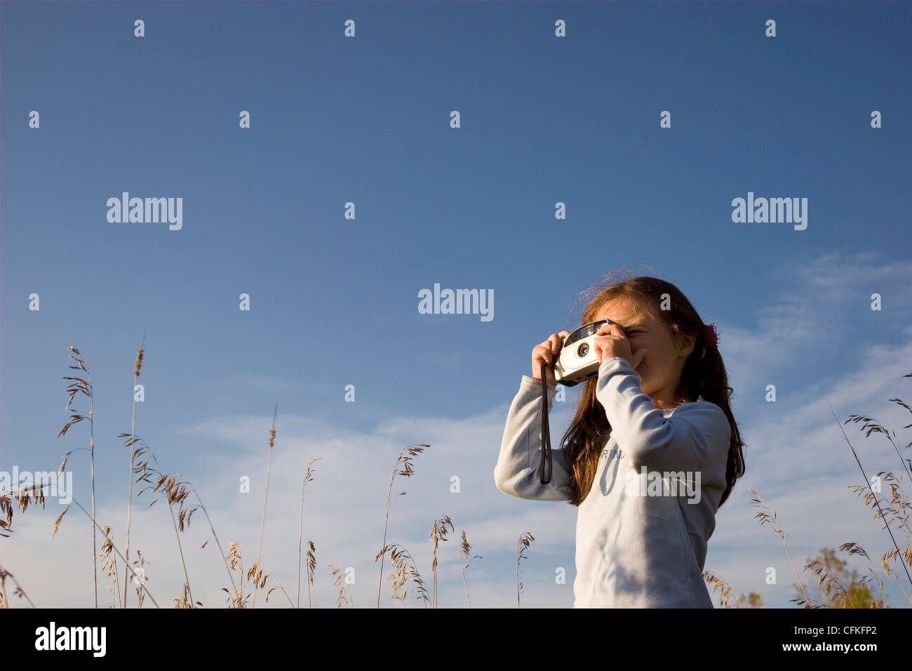 Young Girl Looking through Camera Stock Photo - Alamy