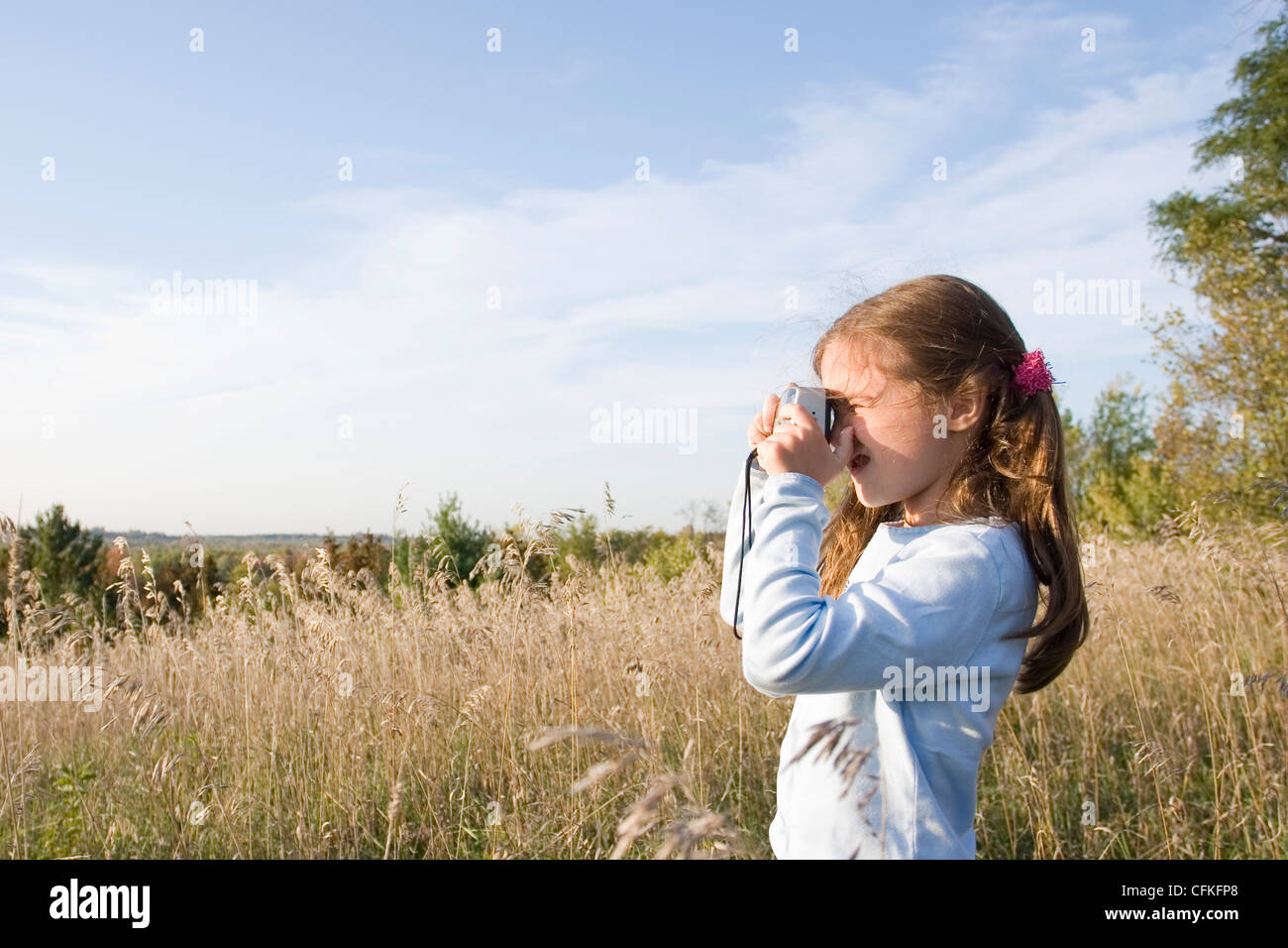 Young Girl Looking through Camera Stock Photo - Alamy