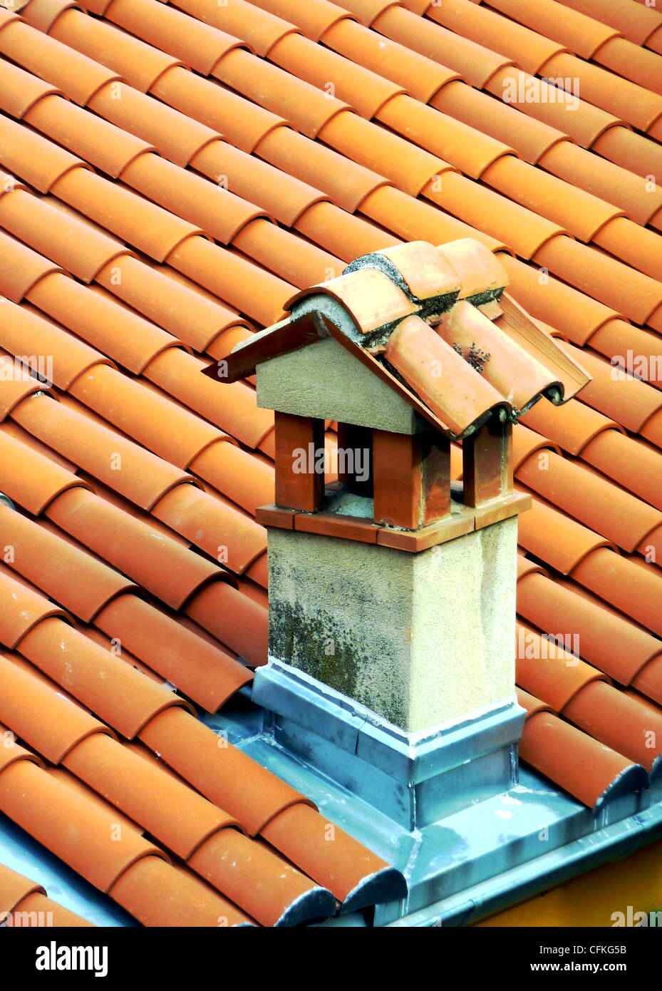 Chimney on a roof made of red tiles Stock Photo - Alamy