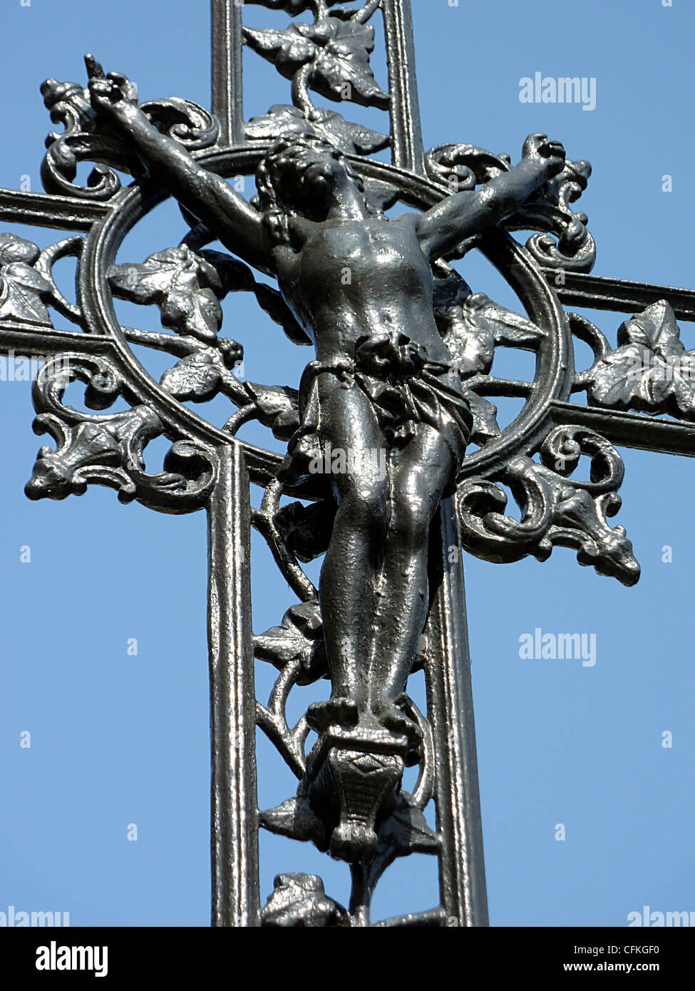 Jesus cross made of black metal with lots of decorations around and ...