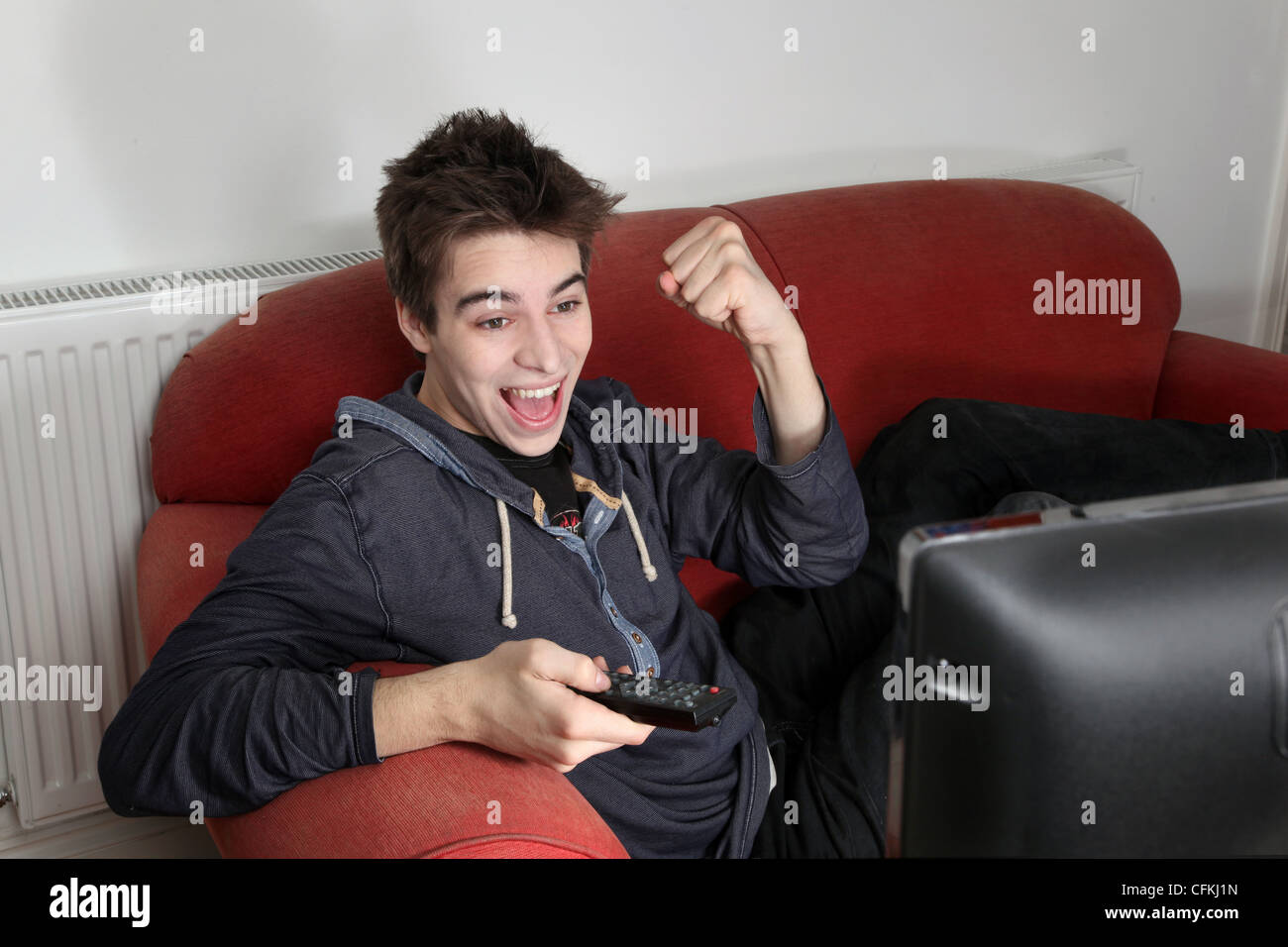 Excited young man punching the air isolated on white background Stock ...