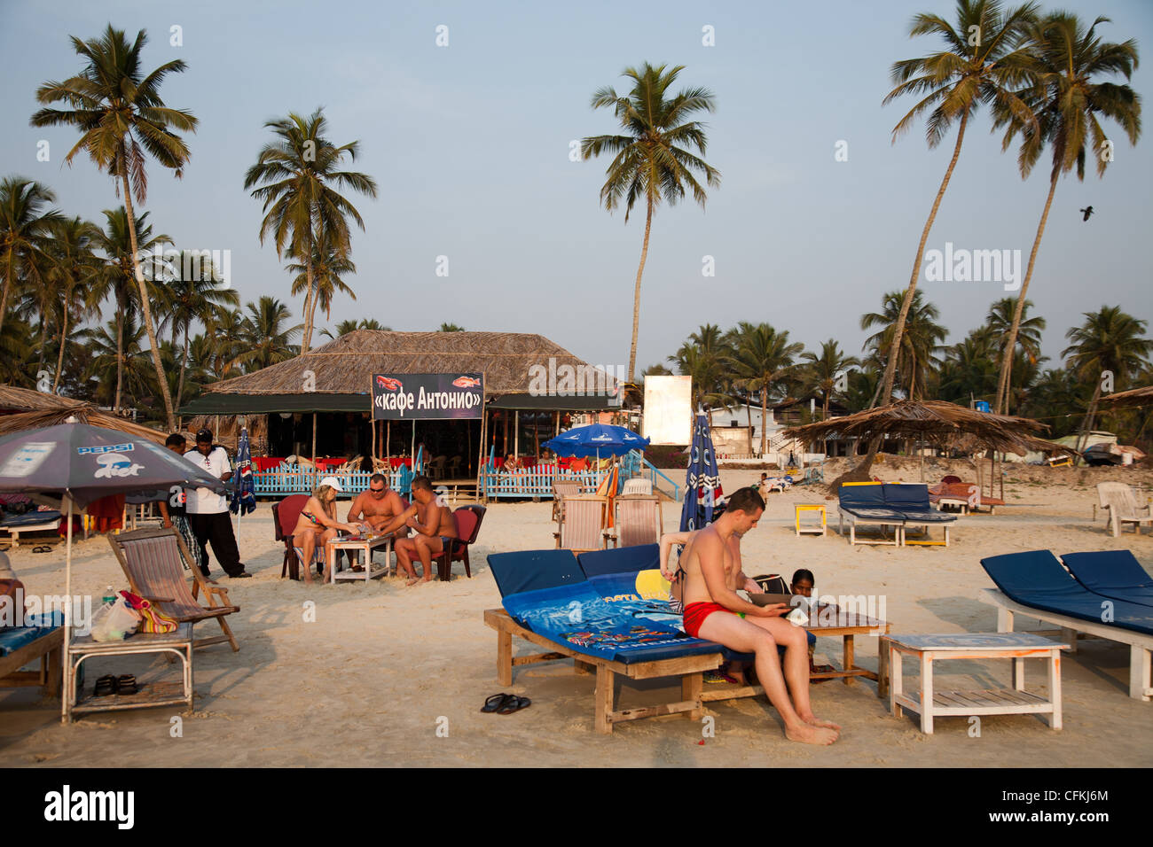 Tourists resting on Colva Beach in India Stock Photo - Alamy