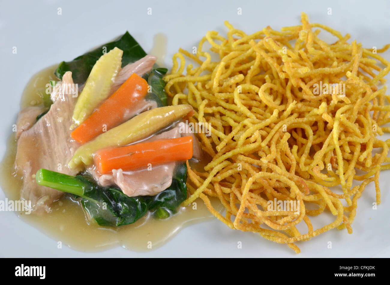 crispy yellow noodle with in a creamy gravy sauce Stock Photo - Alamy
