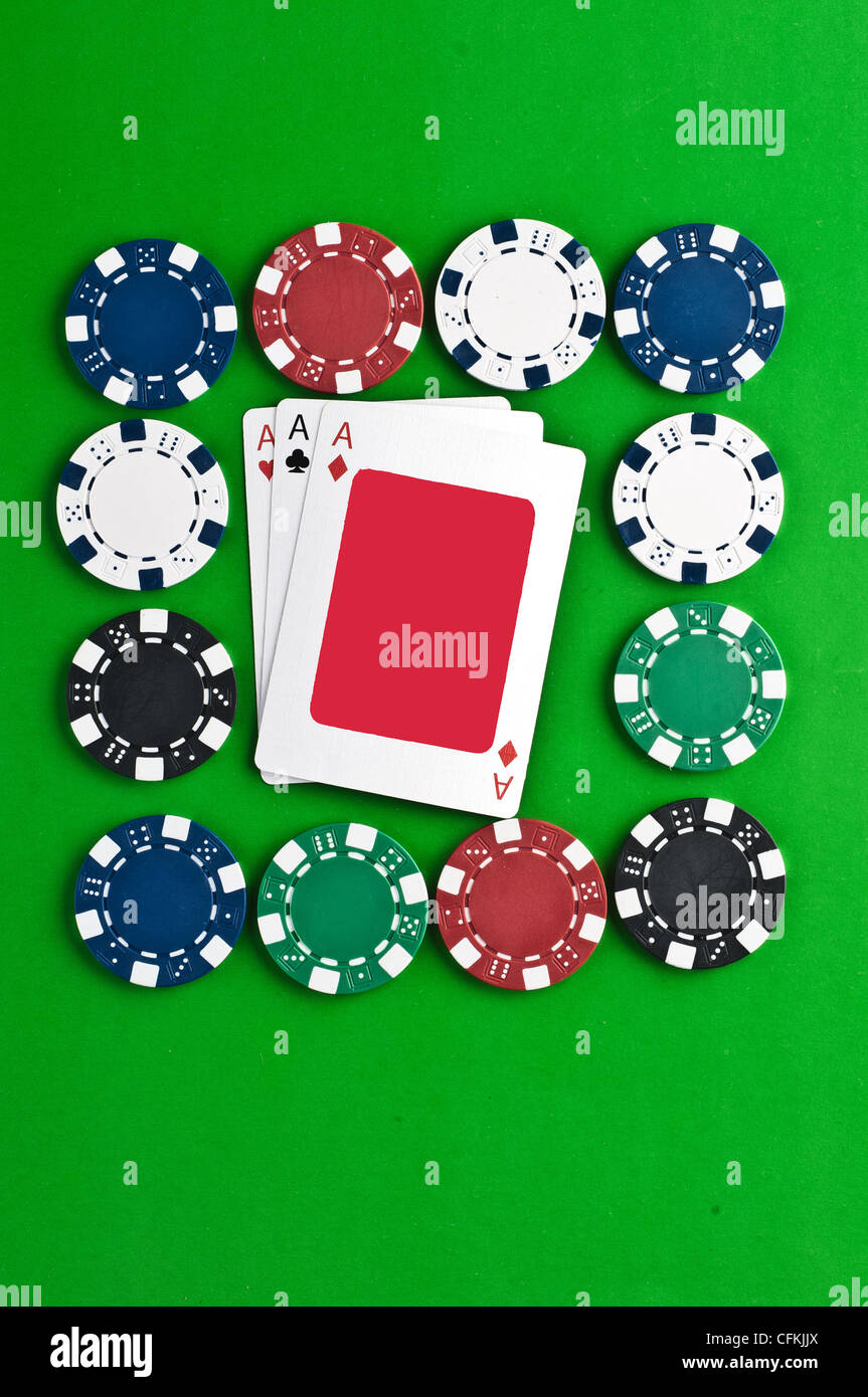 Counters and playing cards on a green background Stock Photo - Alamy