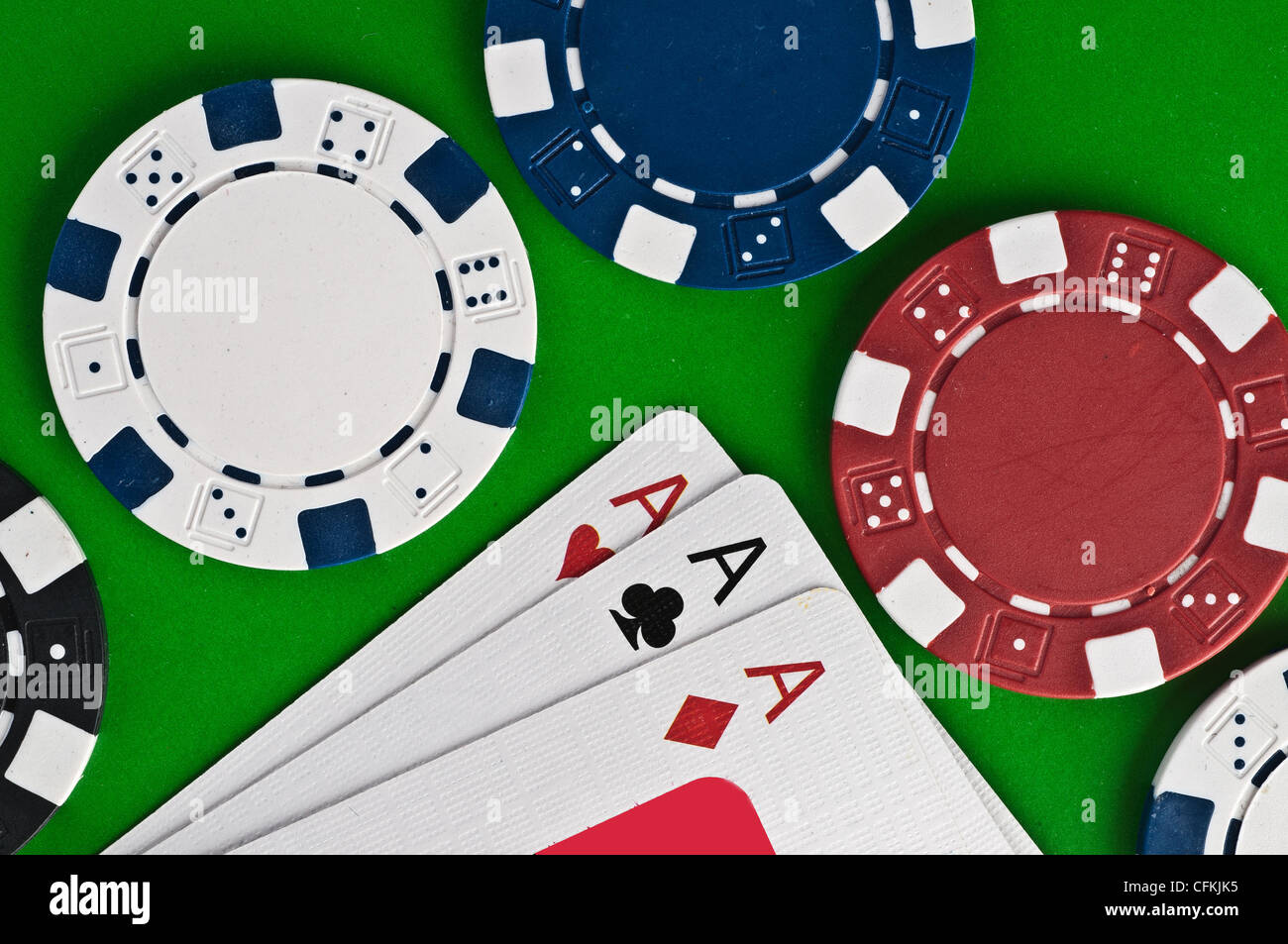Counters and playing cards on a green background Stock Photo - Alamy