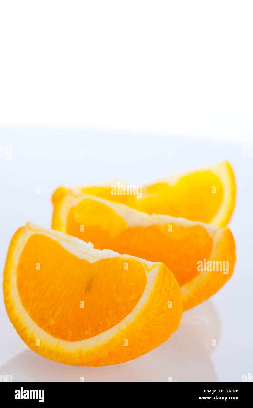 Fresh segments of an orange on a white background Stock Photo - Alamy