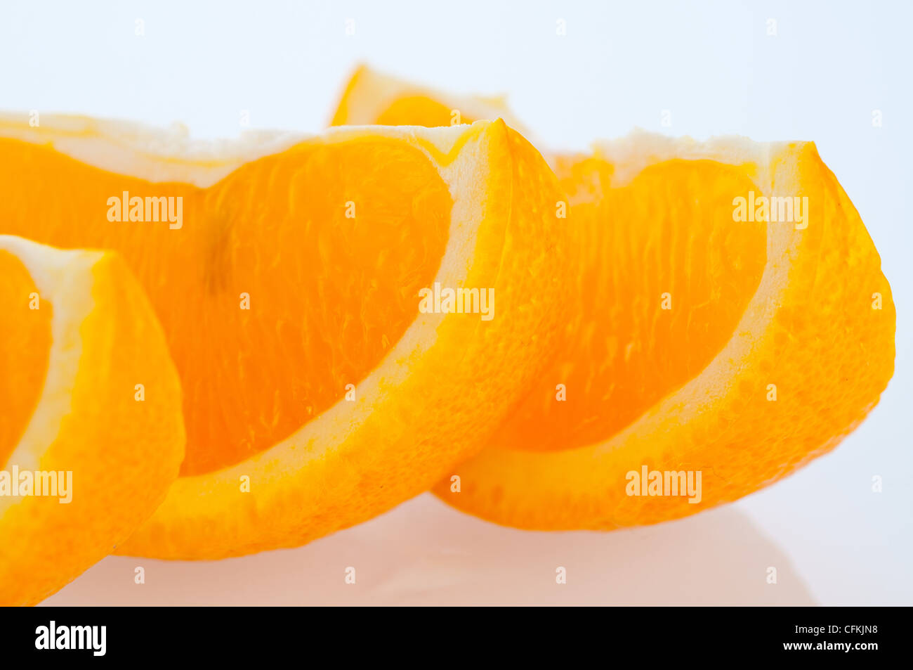 Fresh segments of an orange on a white background Stock Photo - Alamy