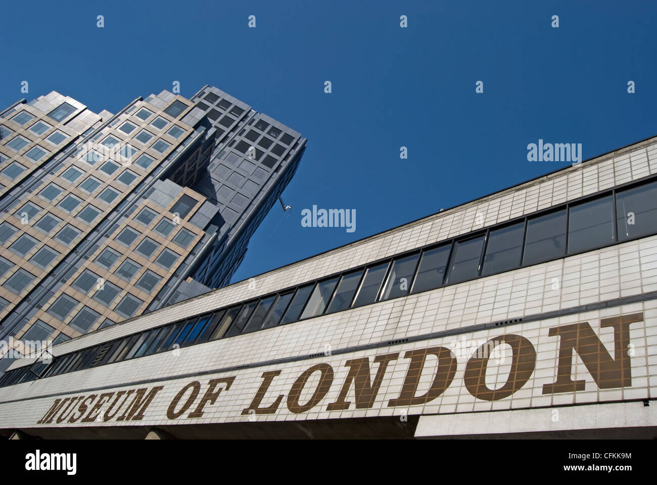 exterior of the museum of london, england, with high rise buildings of ...