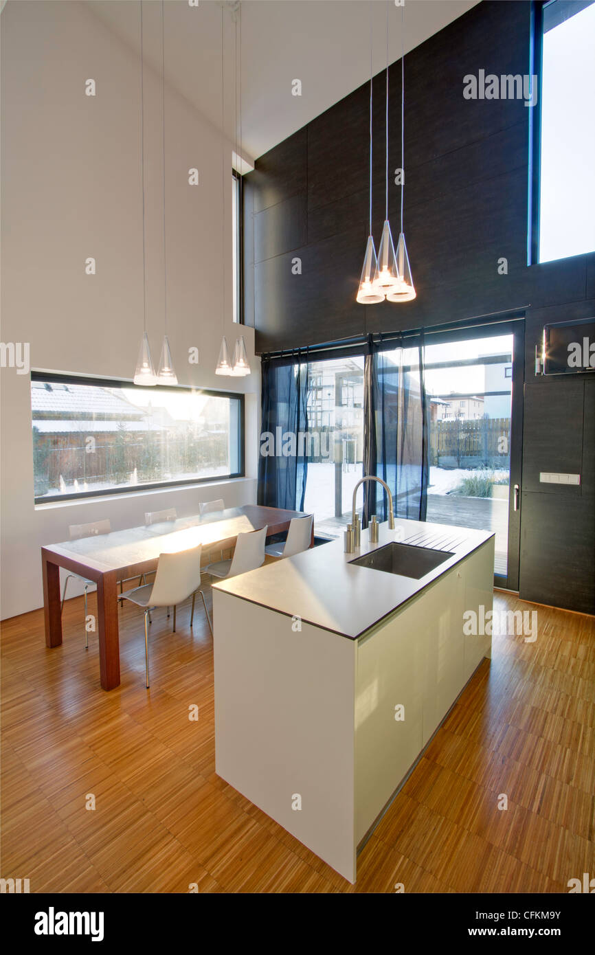 Modern kitchen with dinning table Stock Photo - Alamy