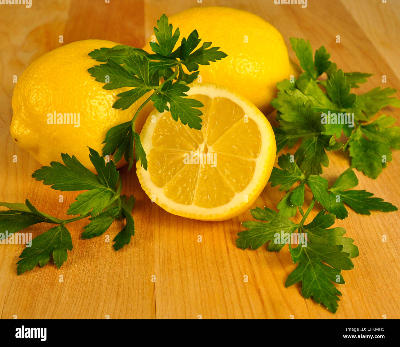 A horizontal close up detail shot of fresh cut lemons and green flat ...