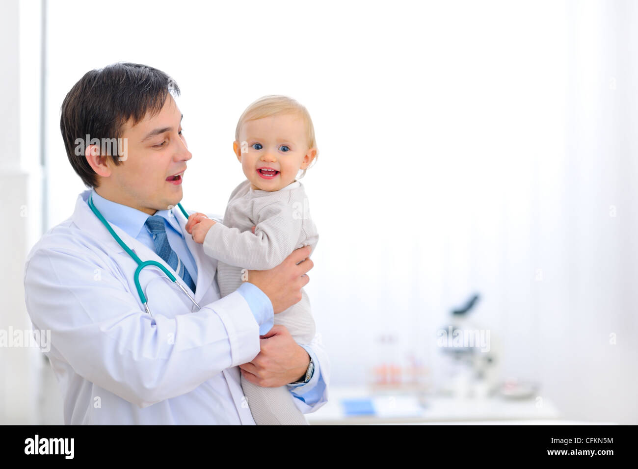 Portrait of happy cute baby on hands of pediatrician Stock Photo - Alamy