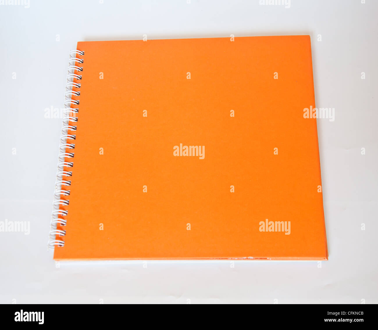 orange notebook on white background Stock Photo - Alamy
