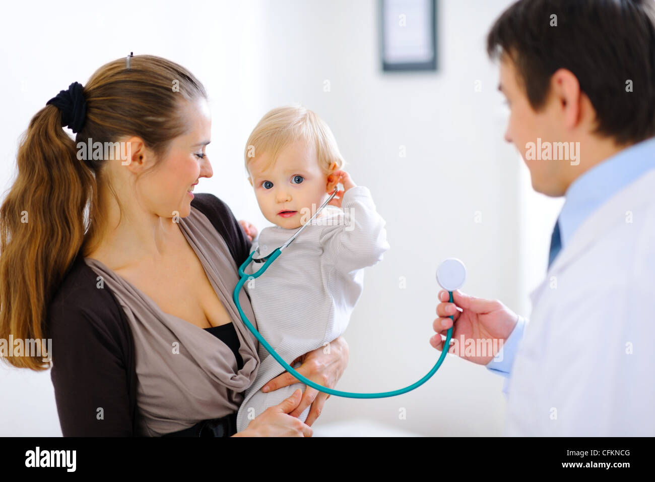 Cute baby on mamas hand playing with stethoscope Stock Photo - Alamy