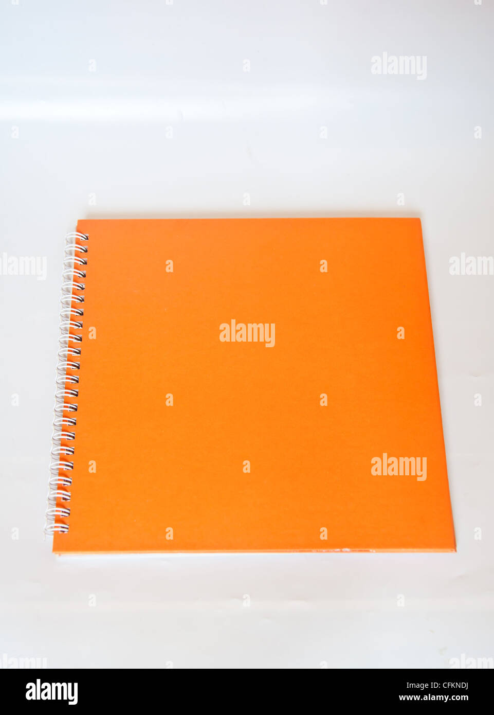 orange notebook on white background Stock Photo - Alamy